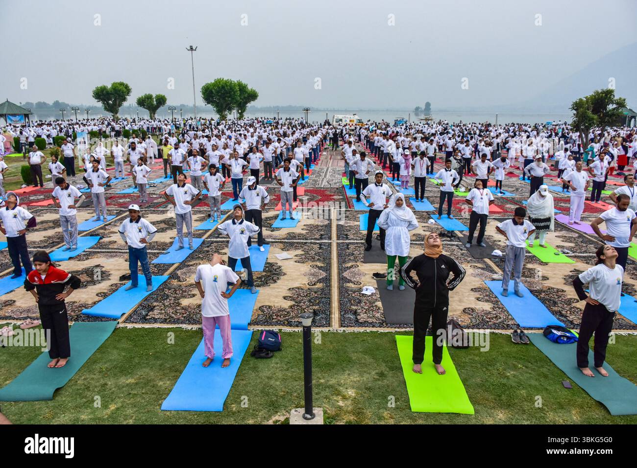 Srinagar, India. 21st June, 2025. Participants perform yoga during a ...