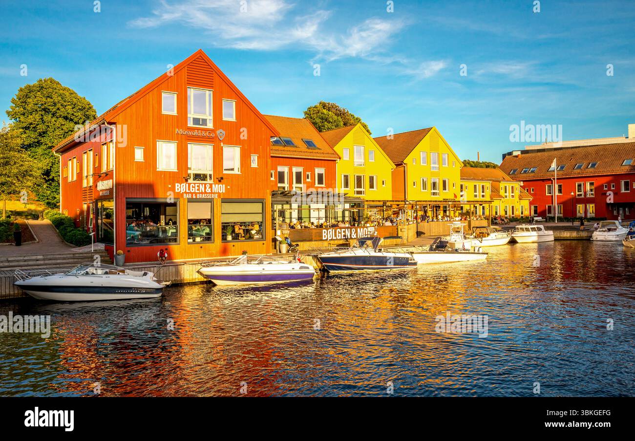 Colorful Waterfront Restaurants and Boats Along a Calm Canal at Sunset ...