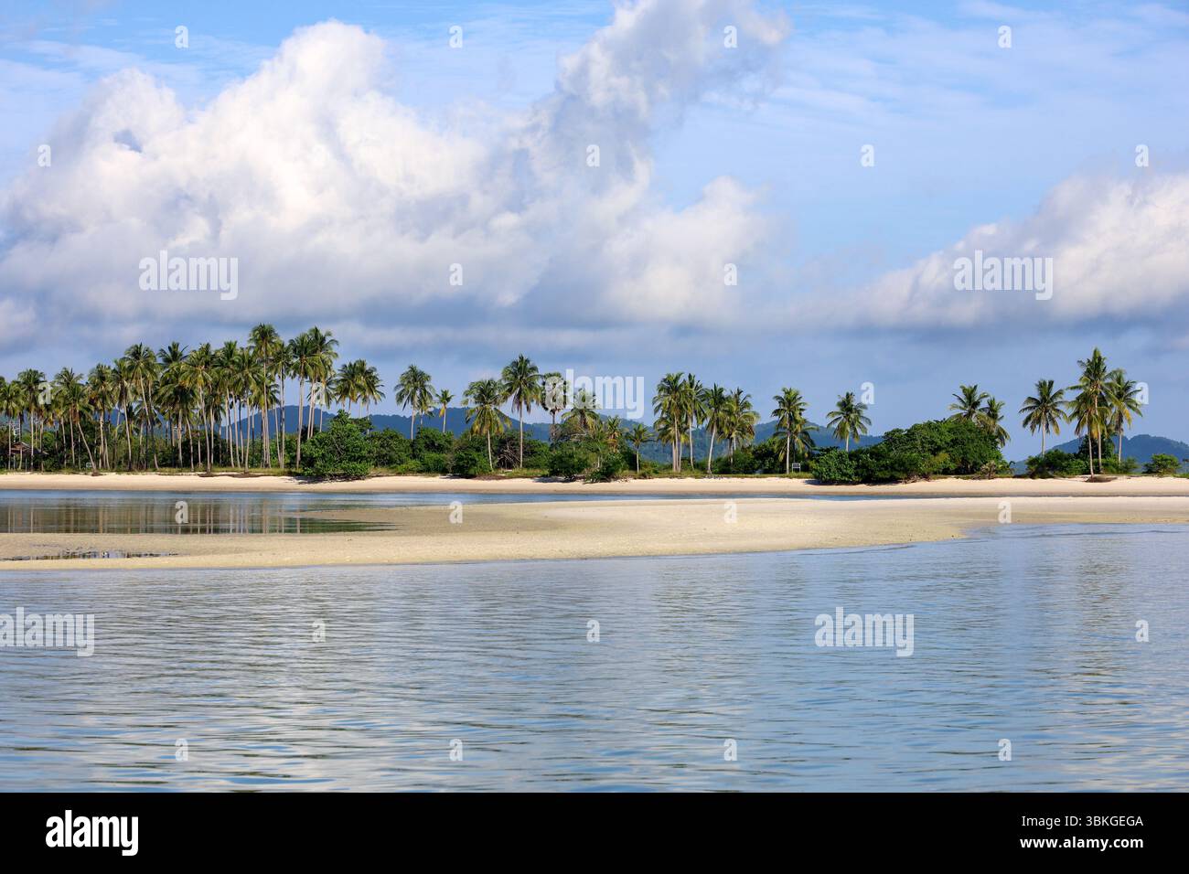 Tropical beach with coconut palm trees, view to sand spit of Yao Yai ...