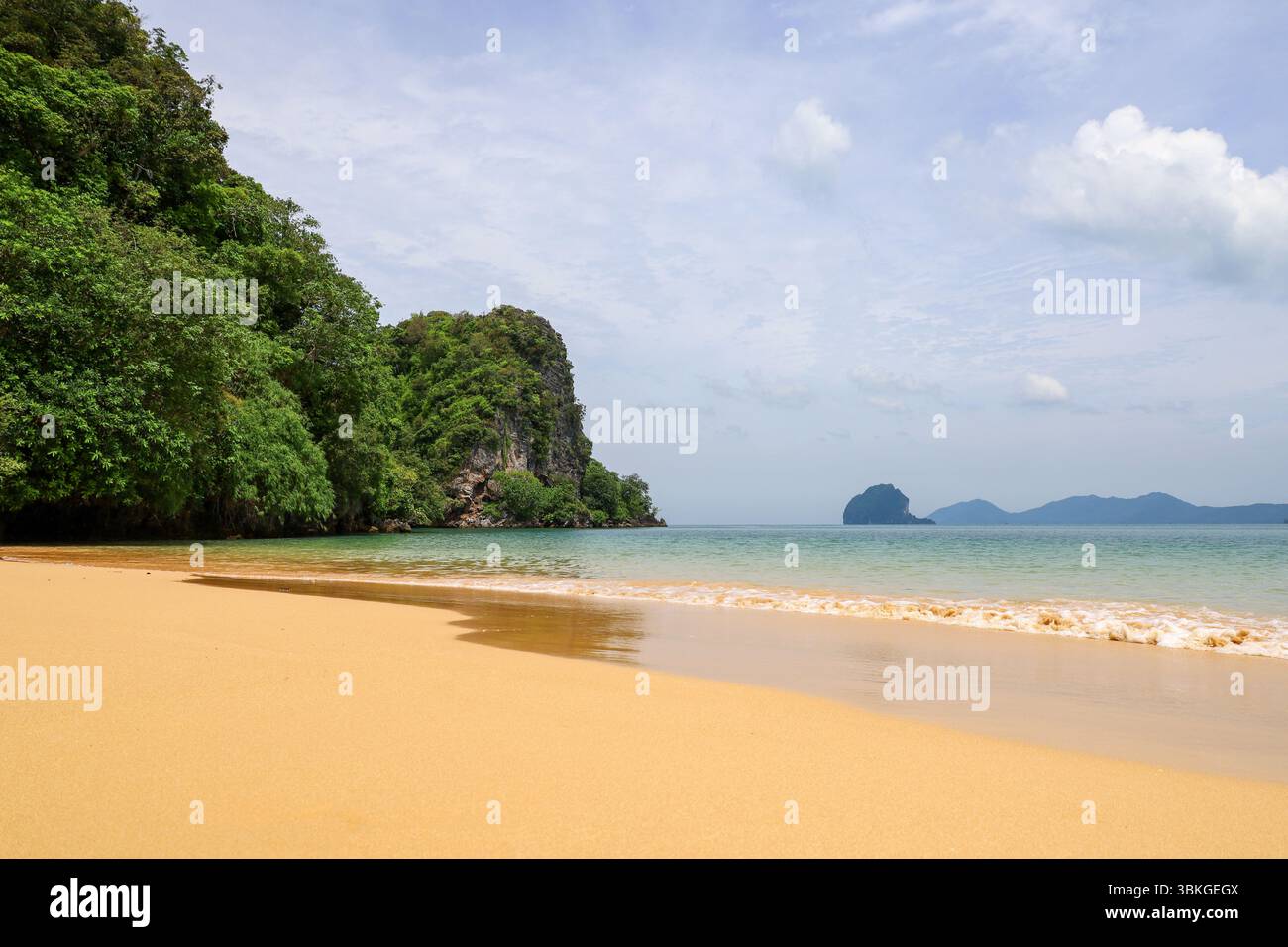 Empty sea beach with tropical plants, view to the sand and rock islands ...