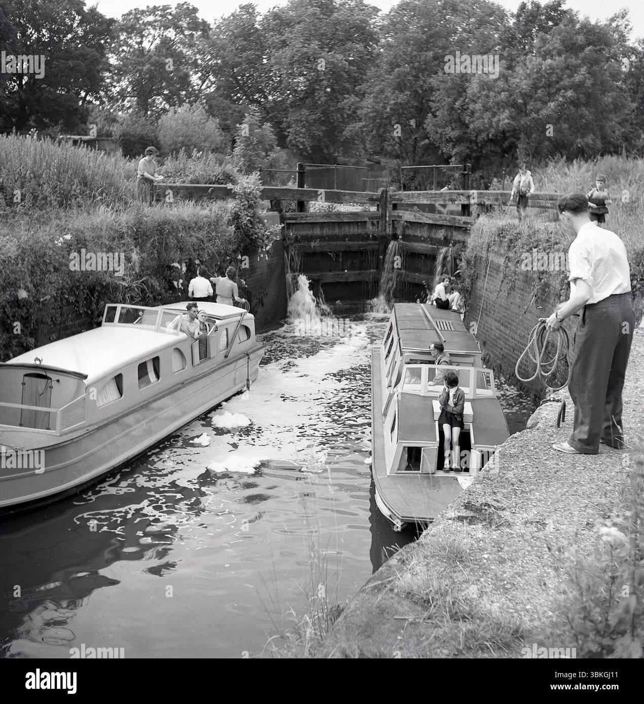 1950s, historical, two narrow boats in a countryside canal lock, top ...
