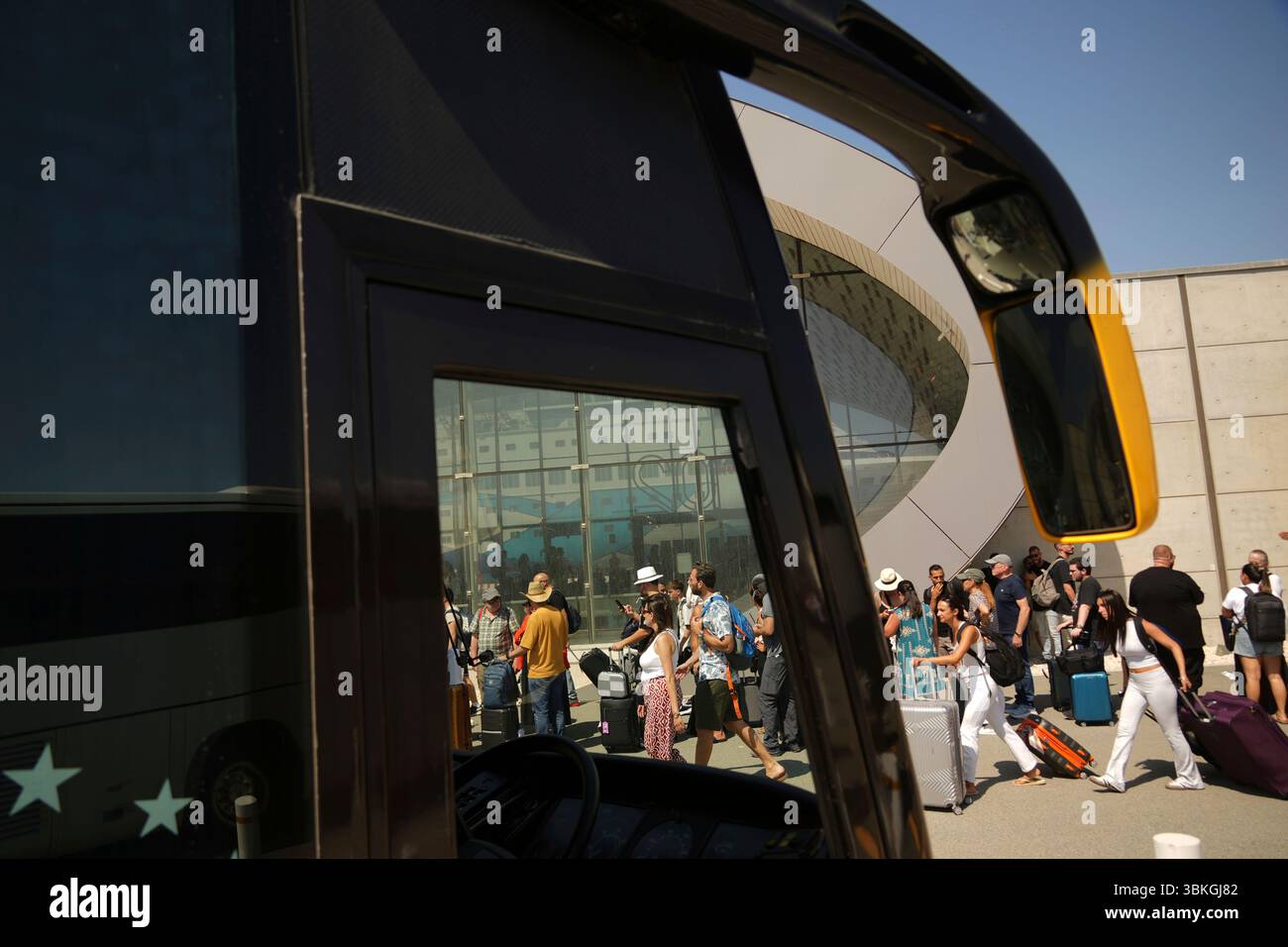 Stranded Israelis line up at the entrance to the departures terminal at Cyprus' main port in ...