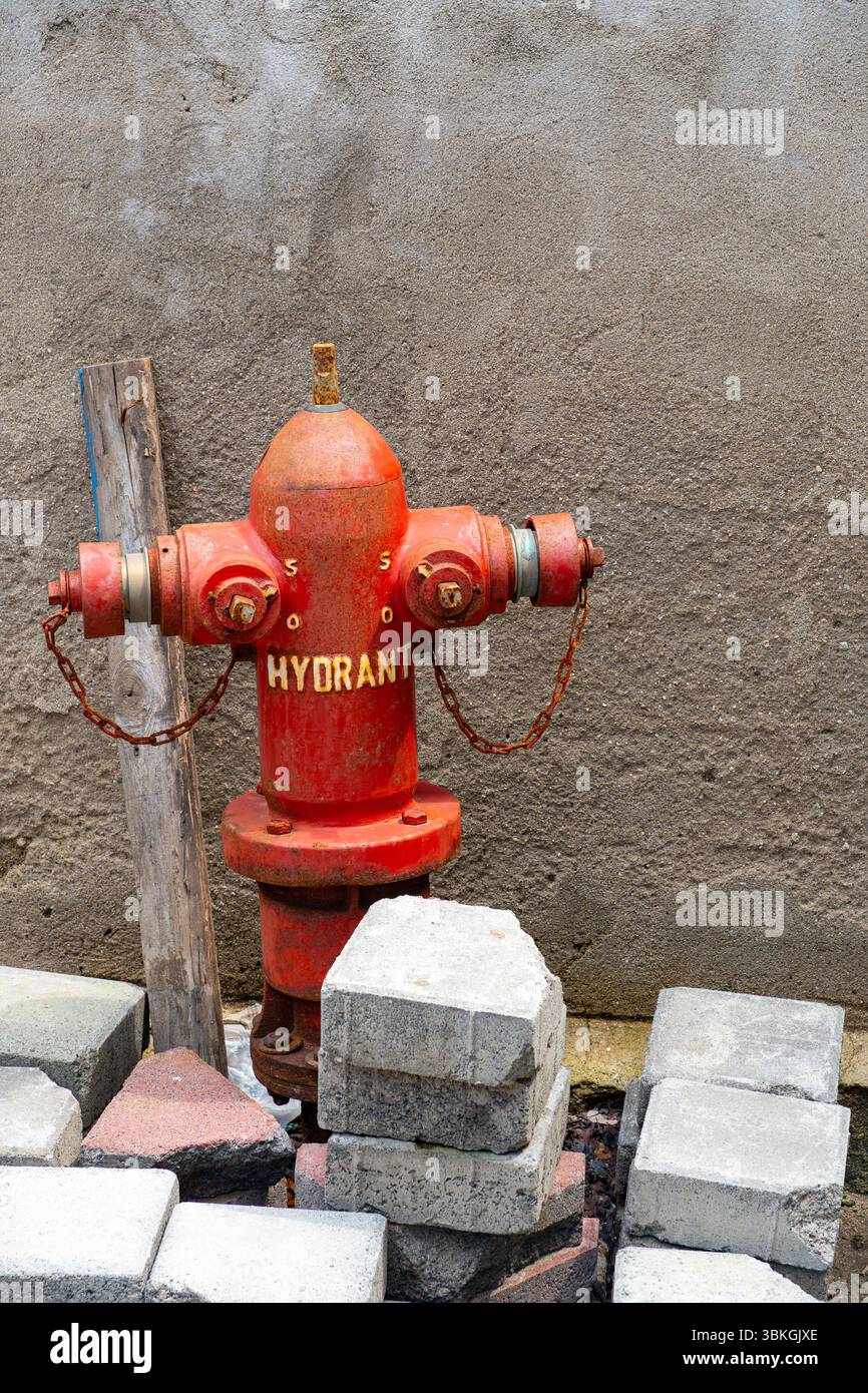 Red fire hydrant with the word hydrant on it Stock Photo - Alamy