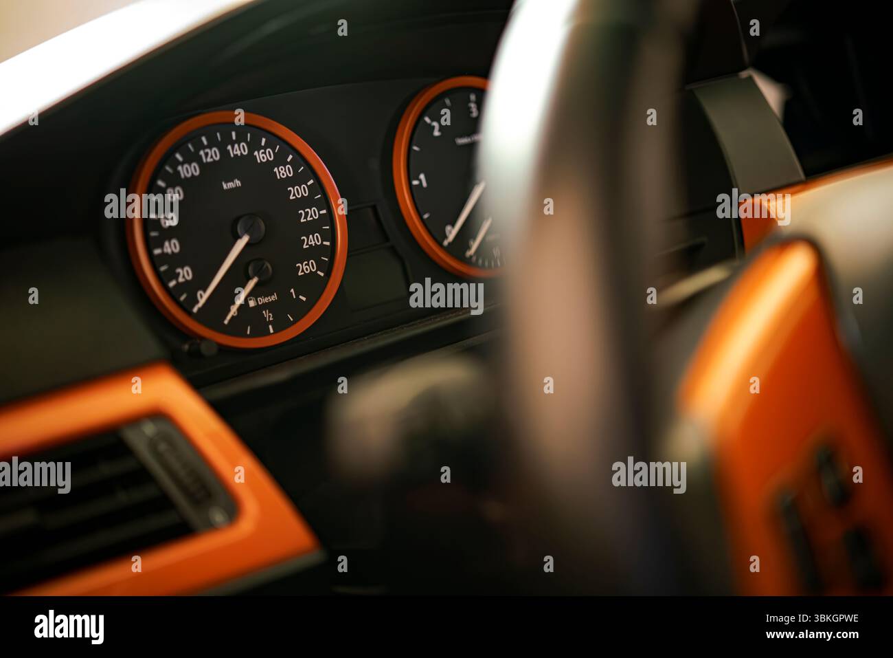 Orange and black car dashboard with speedometer and rpm gauge ...