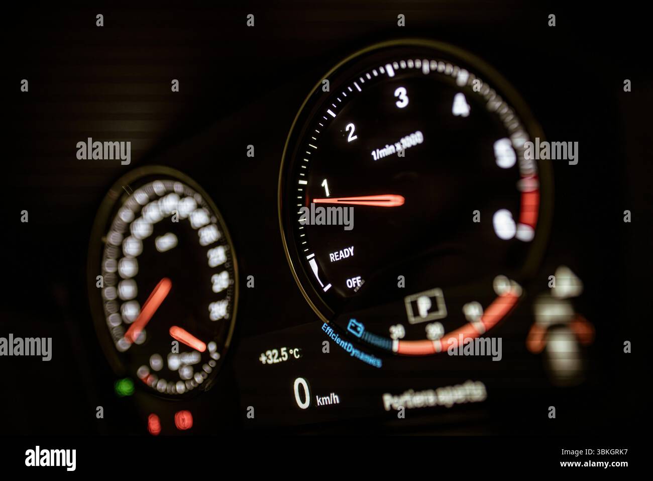 Close up of a car dashboard with illuminated gauges, indicating the ...