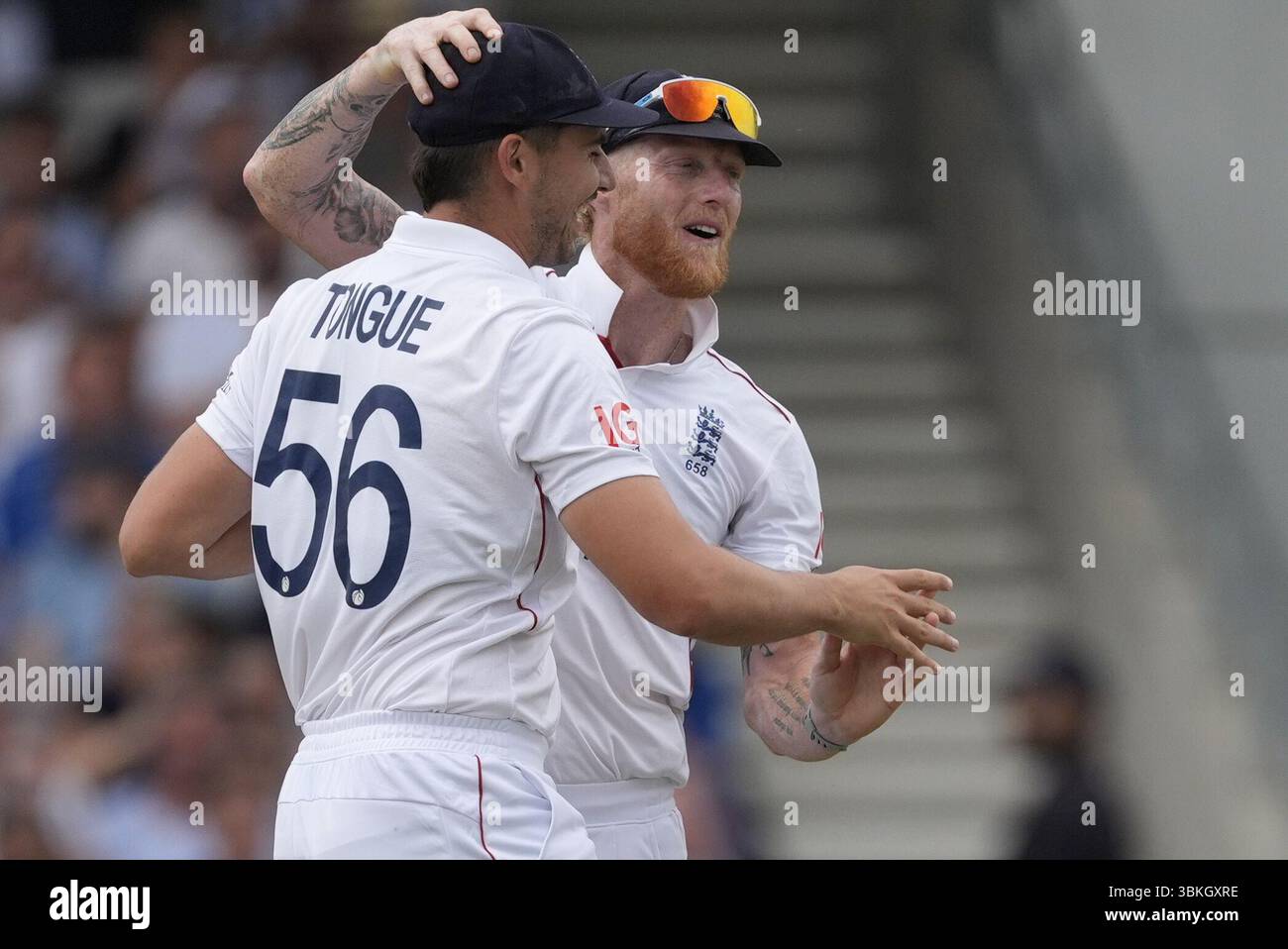 England’s Josh Tongue (left) celebrates taking a catch for the wicket ...