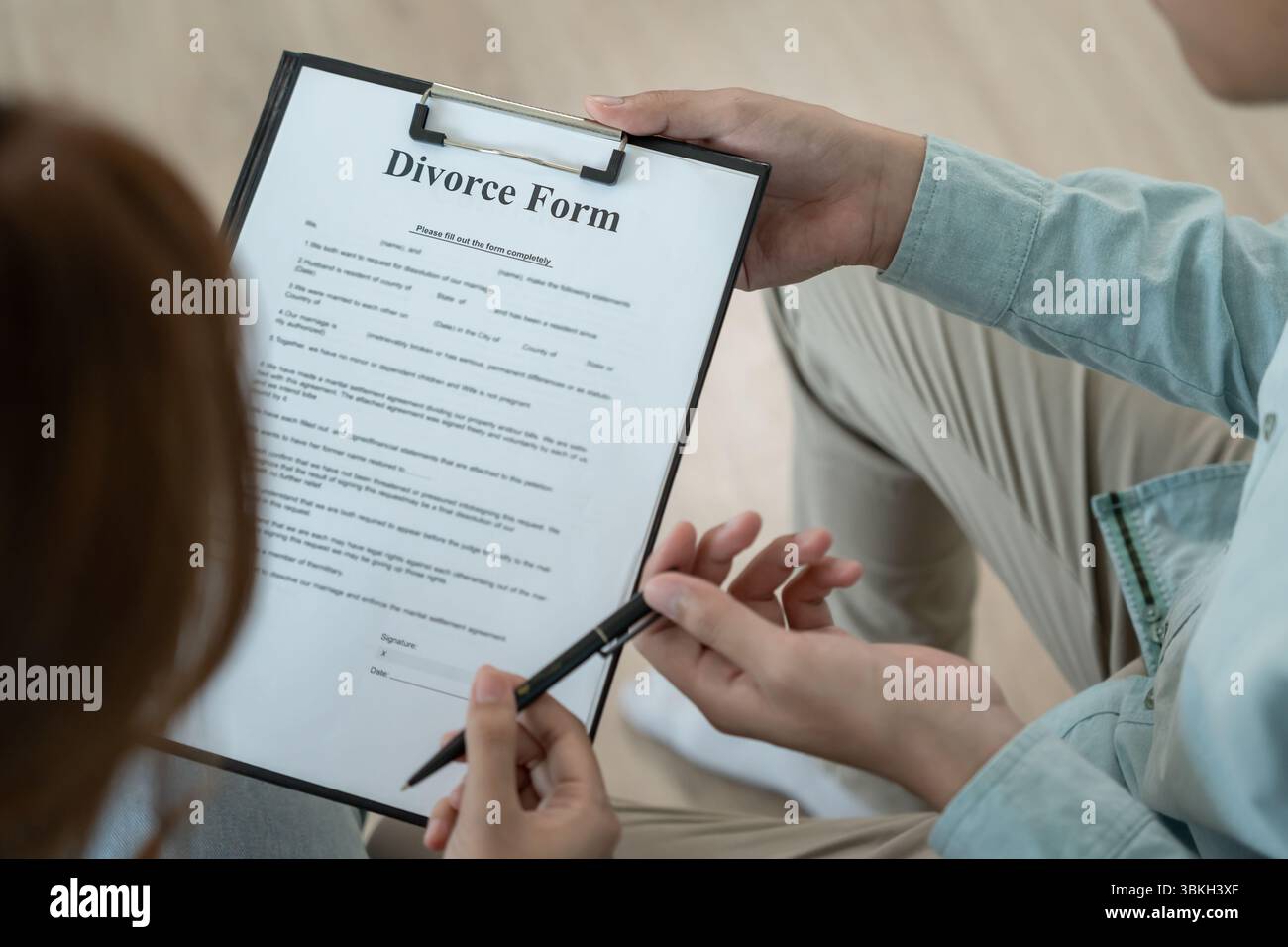 Divorce. Wife review and sign Divorce form. Couples desperate and ...