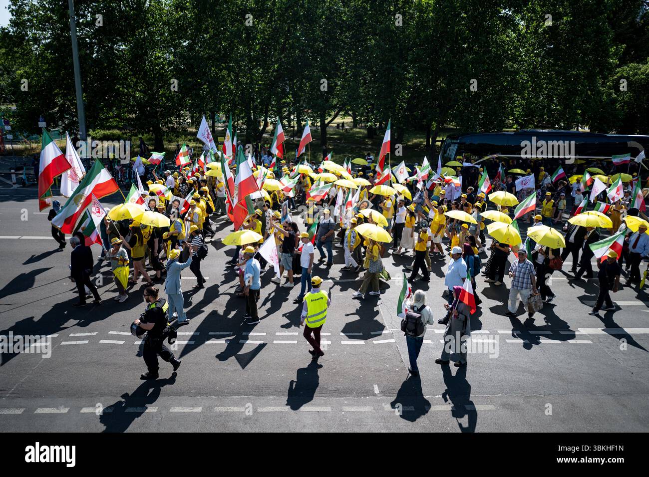 Berlin, Germany. 21st June, 2025. Participants carry yellow umbrellas ...