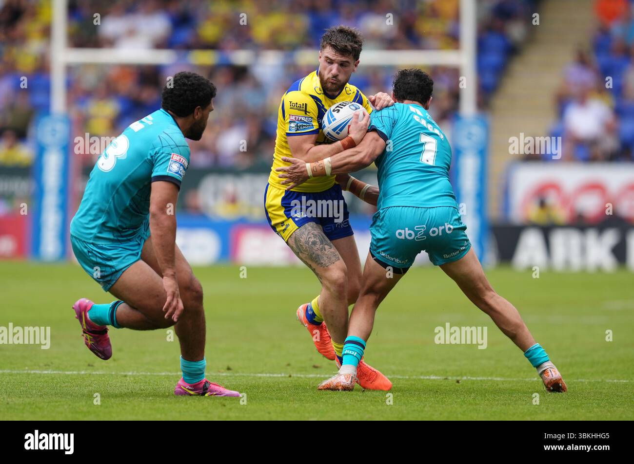 Warrington Wolves' Connor Wrench is tackled by Huddersfield Giants ...