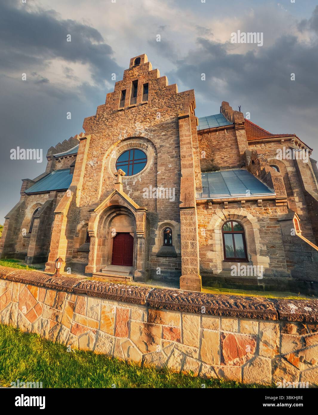 Rural old restored church under cloudy sky. Arches, semicircular ...