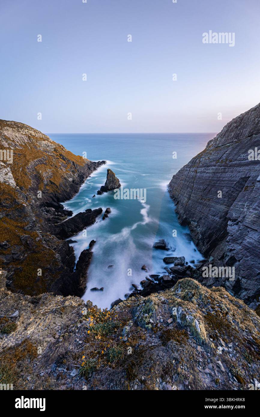 The stunning coastal view showcases serene and calming waves at dusk ...