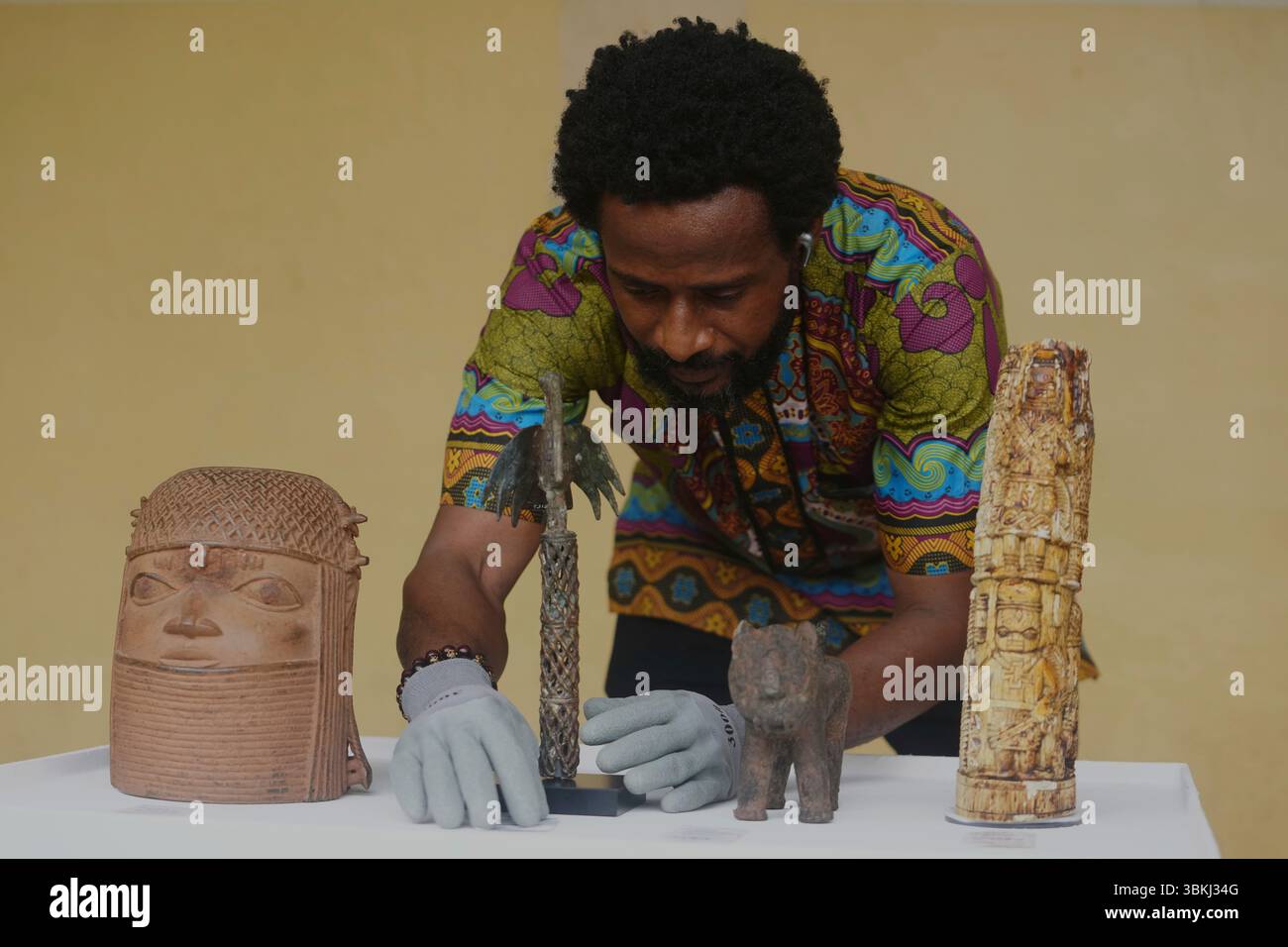 Benin bronzes looted in the past and returned to Nigeria are examined ...