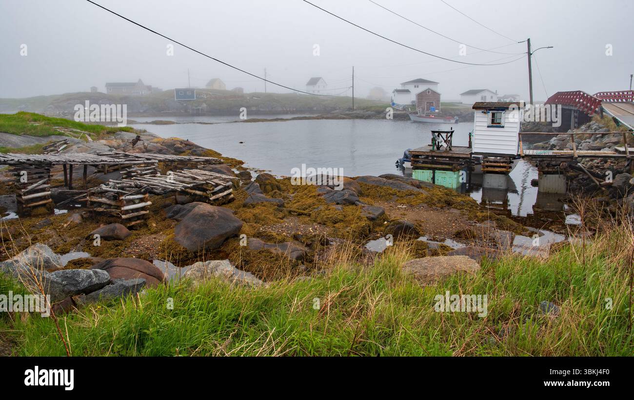 Dense fog over fishing stages and the narrow bridge to Ship Island at ...