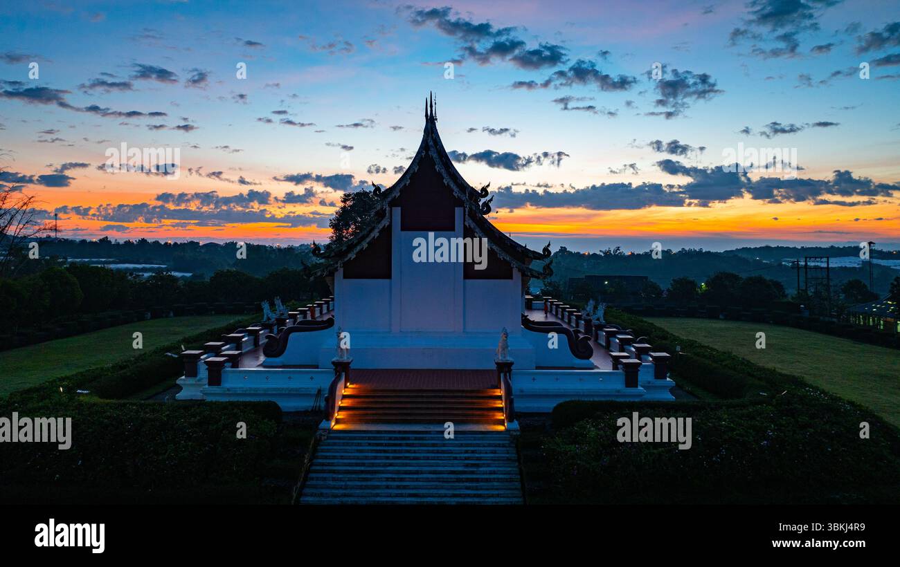 Aerial view of a traditional temple surrounded by greenery under a ...