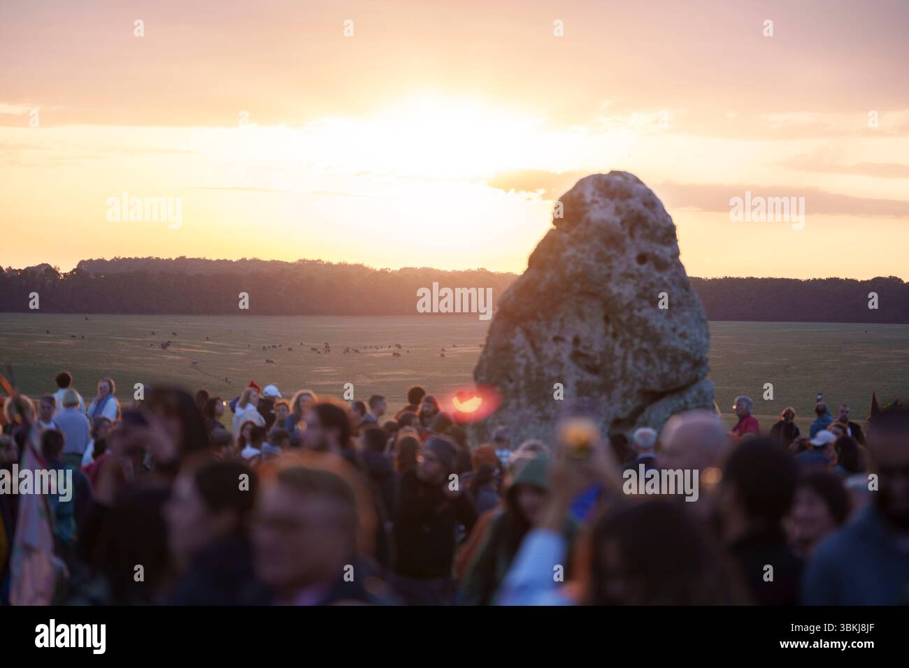 Spiritual revellers watch the rising sun over the Heel Stone and ...