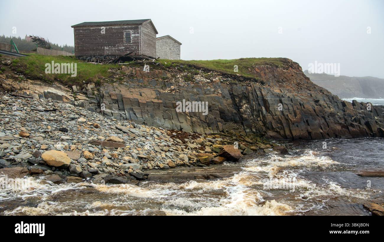 Abandoned houses perch on the brink of the rocky cliffs in Maberly ...