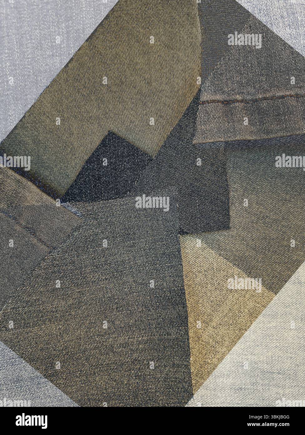 Pieces of material overlap in tan, yellow & gray jean patchwork. The ...