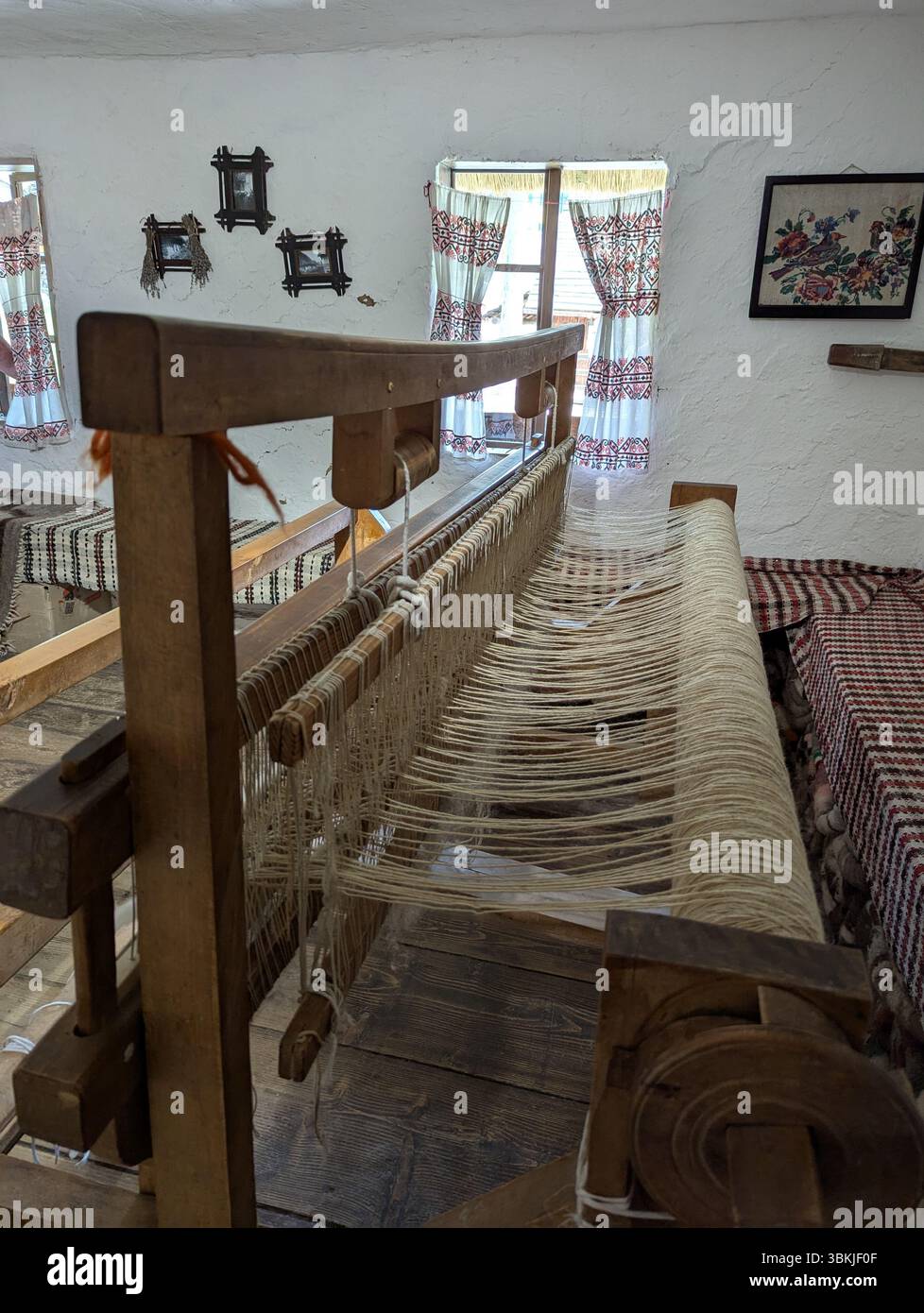 The ancient weaving loom in an interior of a wooden log hut Stock Photo ...