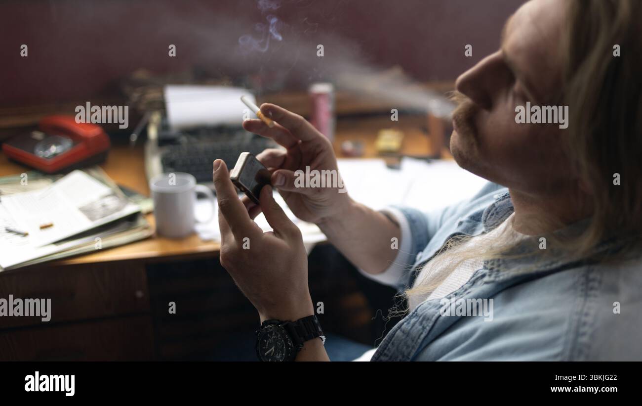 Man lost in thought while smoking, dim office lighting, cinematic ...