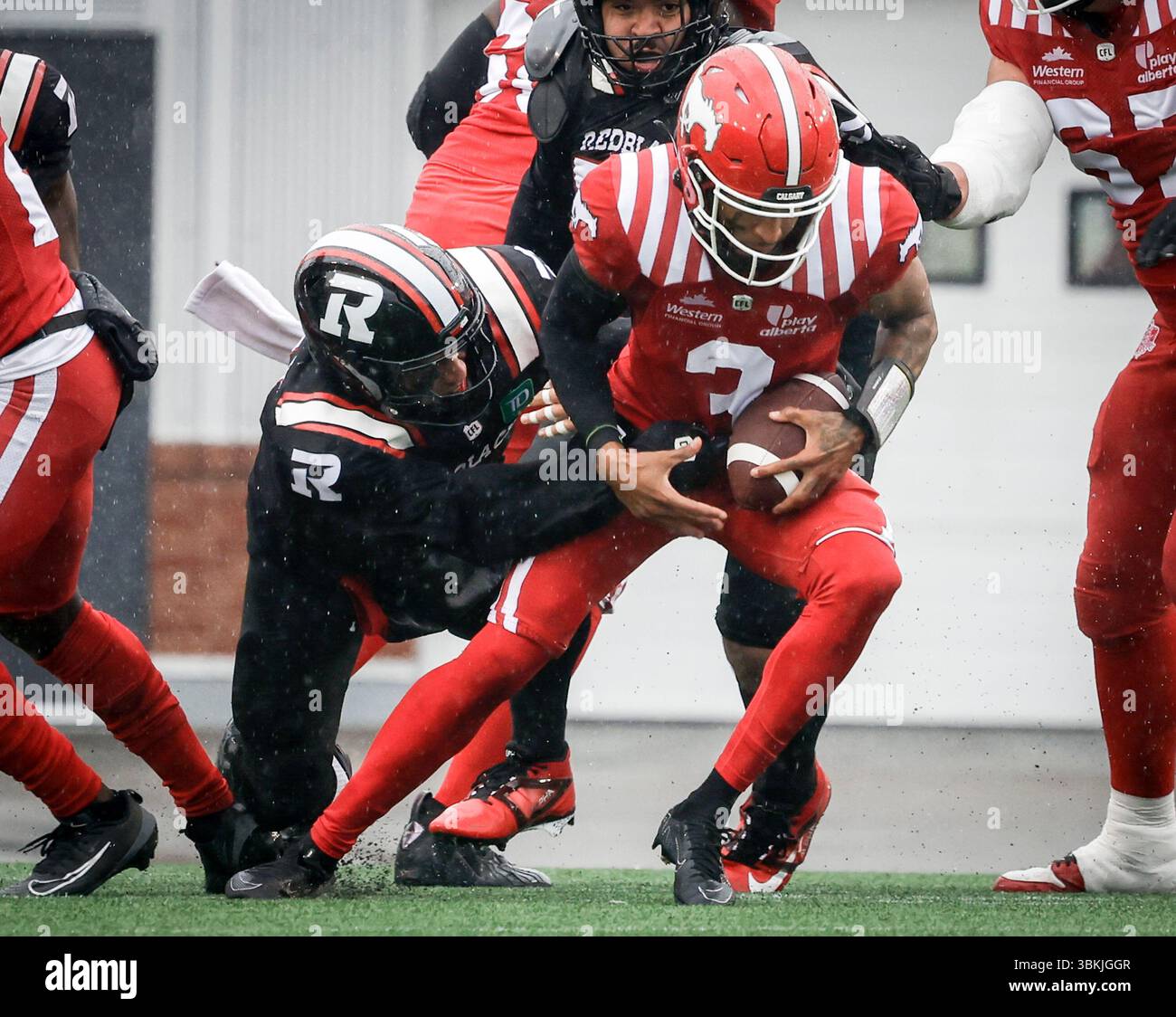 Ottawa Redblacks' Jovan Santos-Knox, center left, sacks Calgary ...
