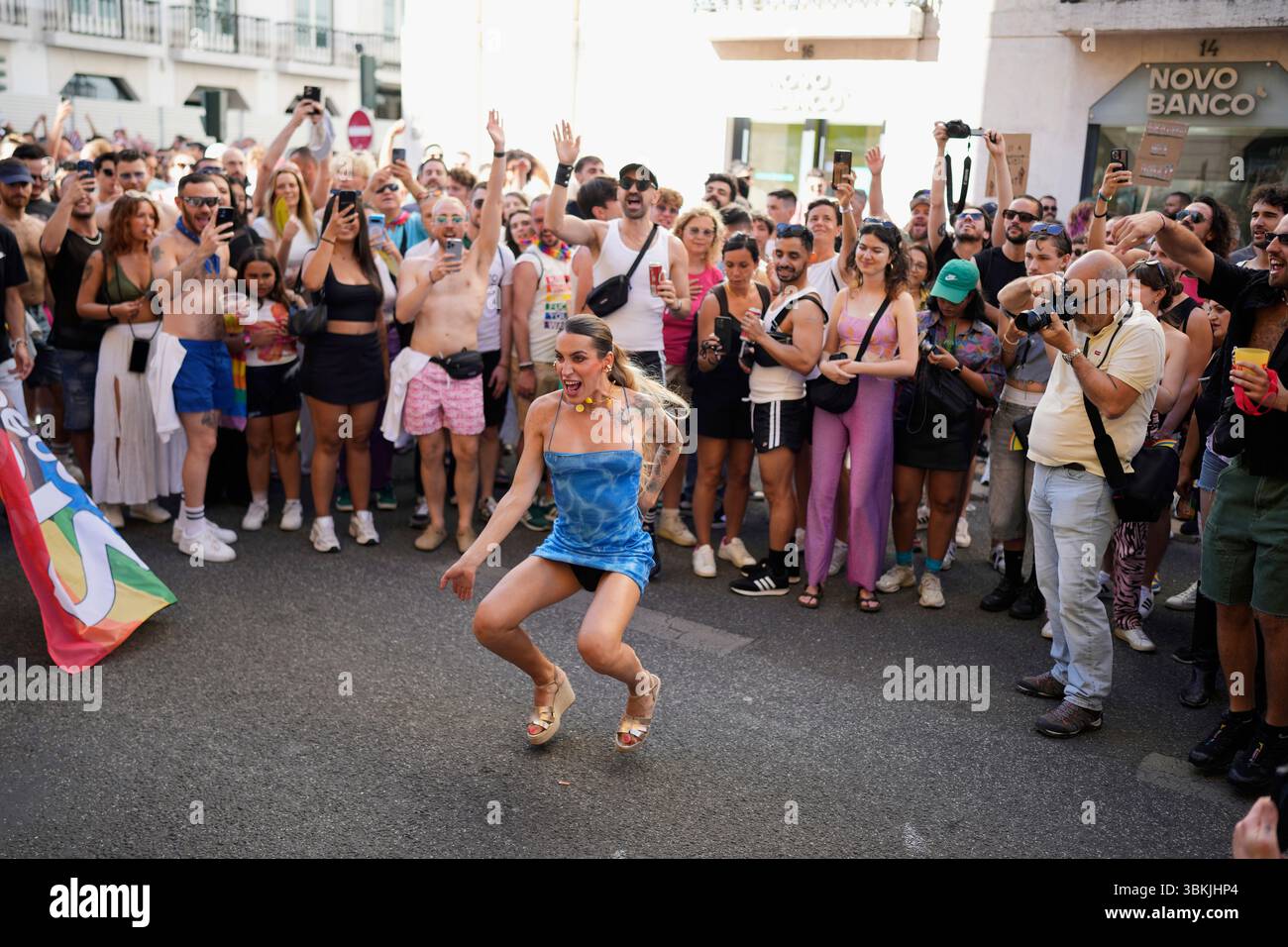 The crowd opens a circle to watch a reveler dance to Spanish music ...