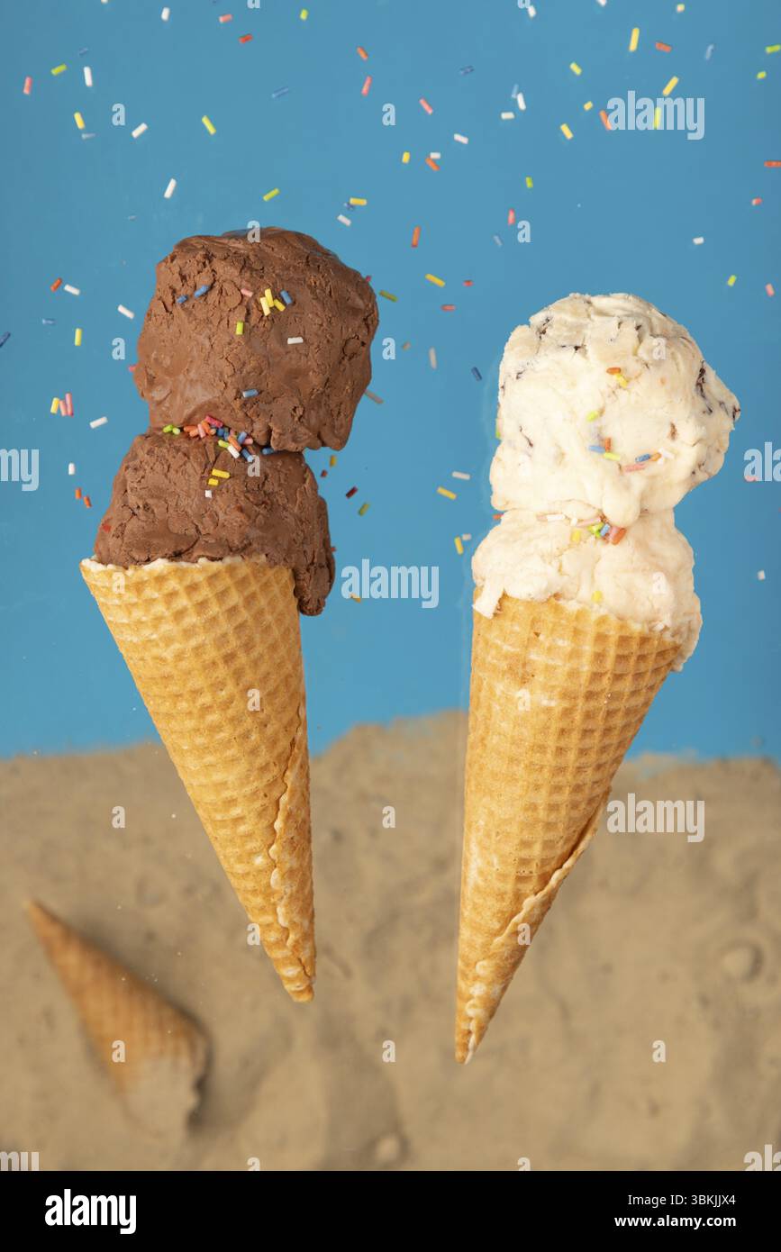 Two ice cream cones, one with chocolate ice cream and one with cream ...