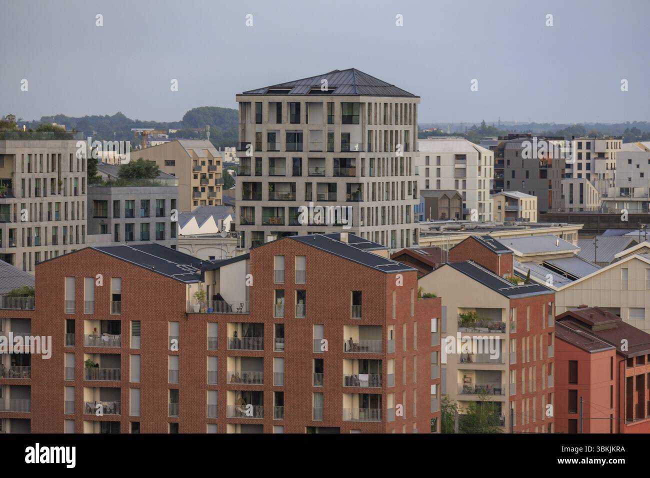 Modern residential building under a dusky sky with brick and glass ...