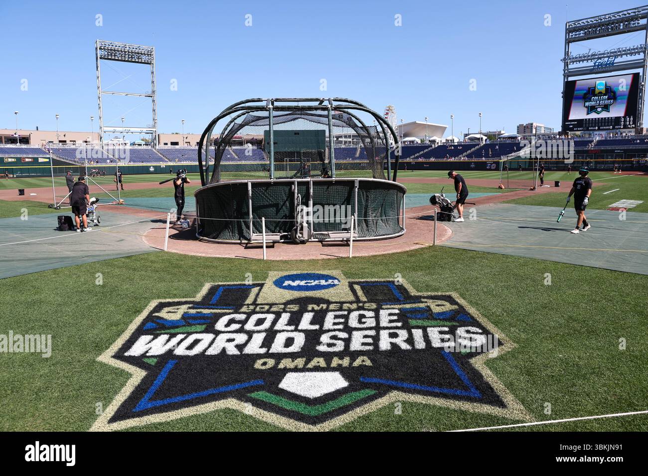 Omaha, NE, USA. 21st June, 2025. The College World Series logo is painted on the field behind ...