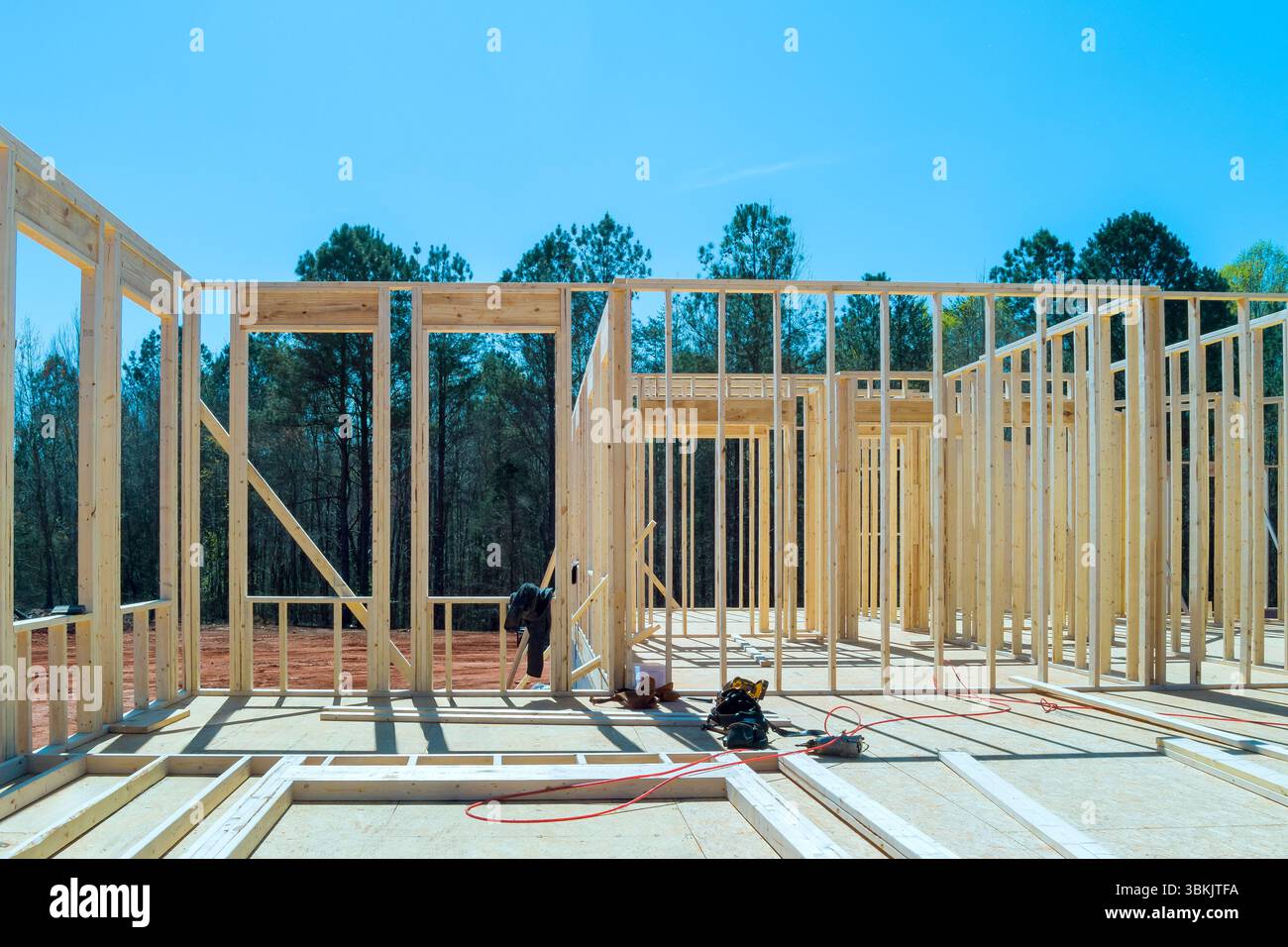 Construction crew installs wooden frames beams for new house under ...