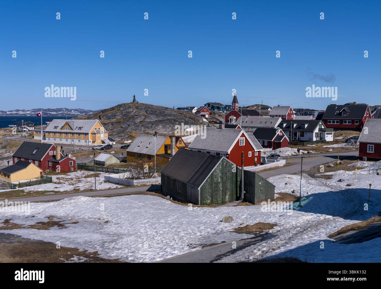 Collection of homes with Hans Egede statue on hilltop by Church of our ...
