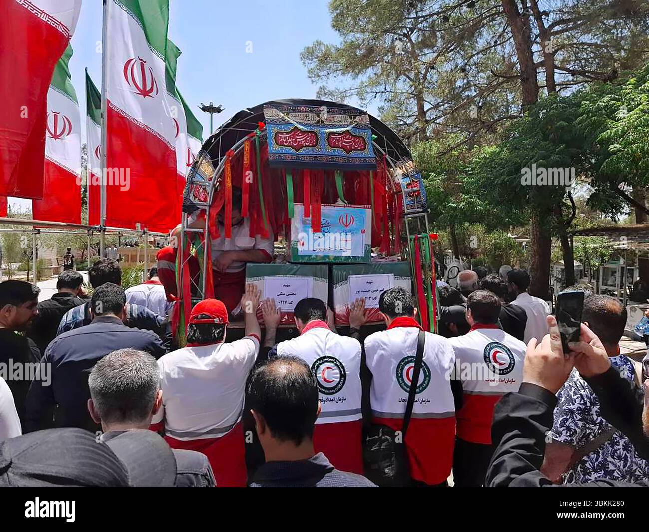 Tehran, Iran. 21st June, 2025. Iranians mourn during a funeral of two ...