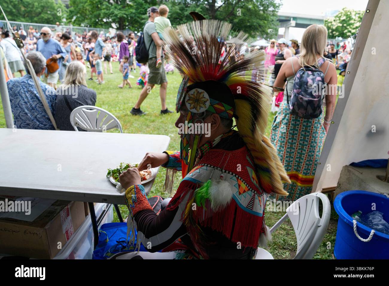 A member of the First Nation eats his lunch at the Traditional Pow Wow ...