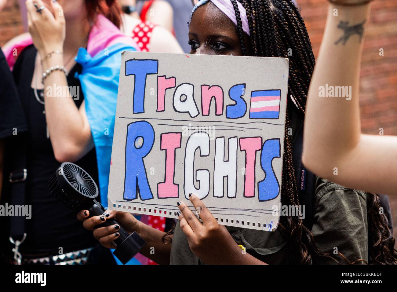 Nottingham, UK. 21 JUN, 2025. Person holds trans rights sign as Counter ...