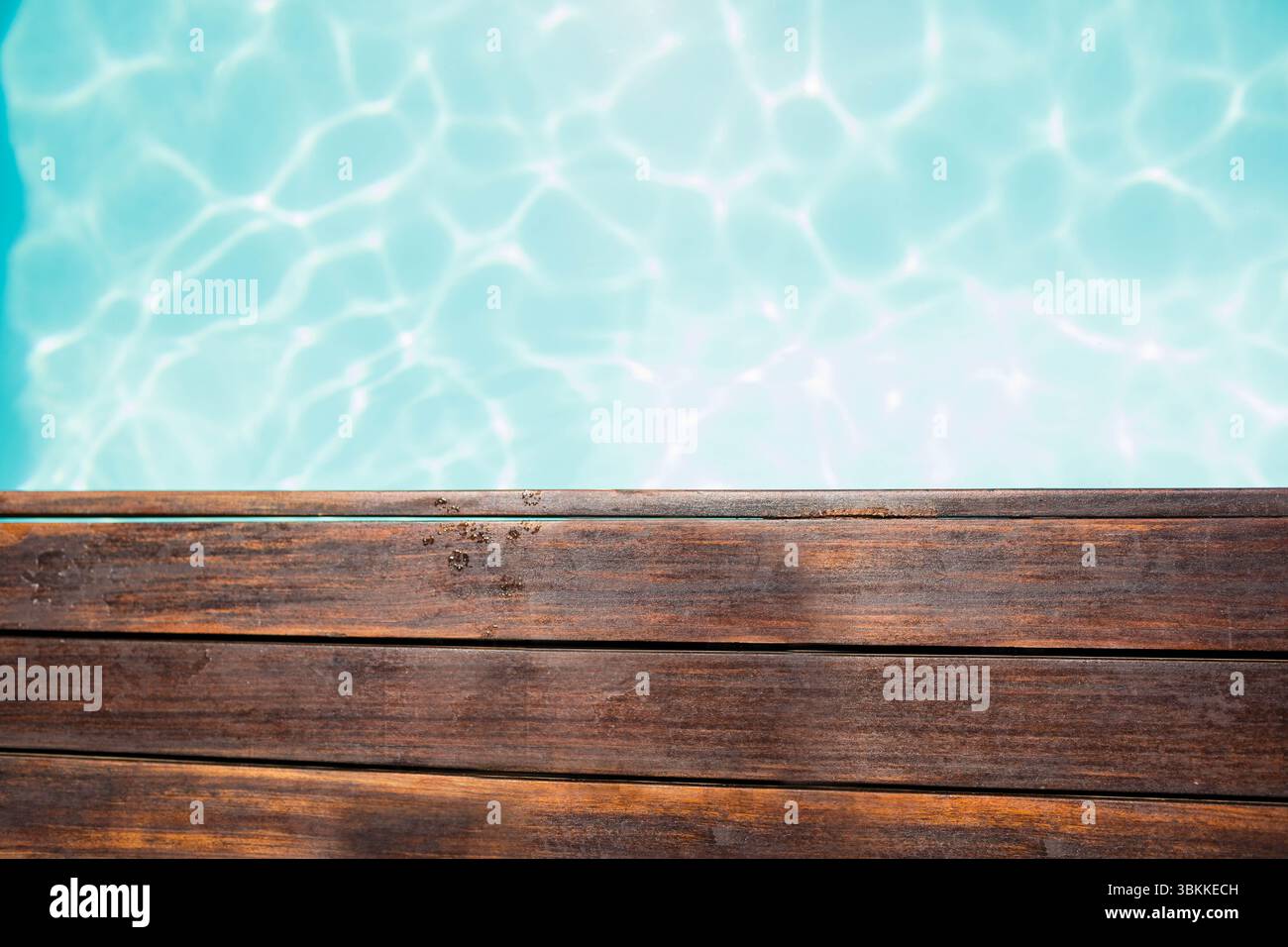 Wooden pier by swimming pool Stock Photo - Alamy