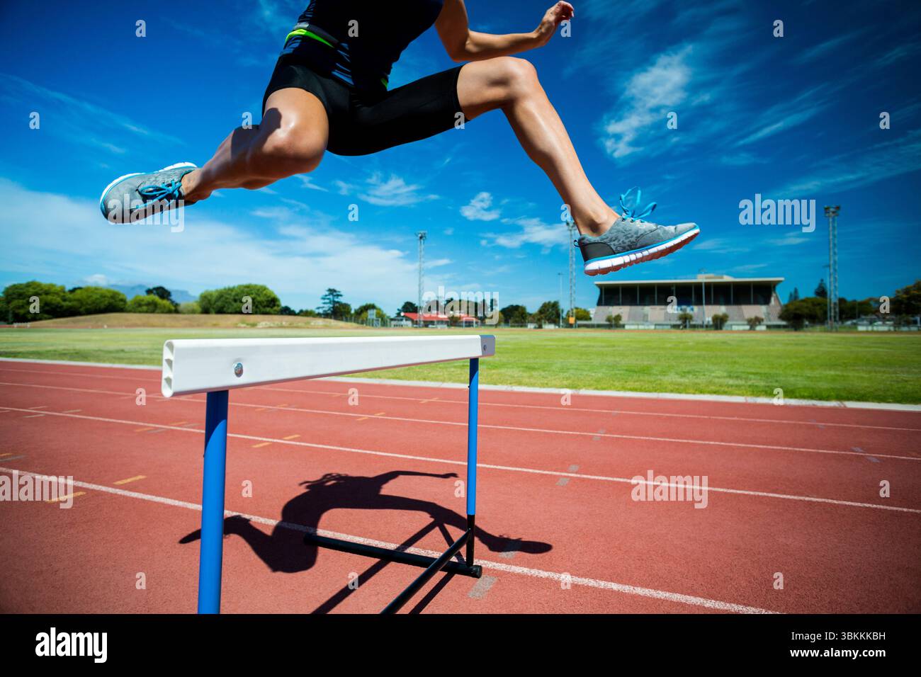 Athletic woman doing show jumping Stock Photo - Alamy