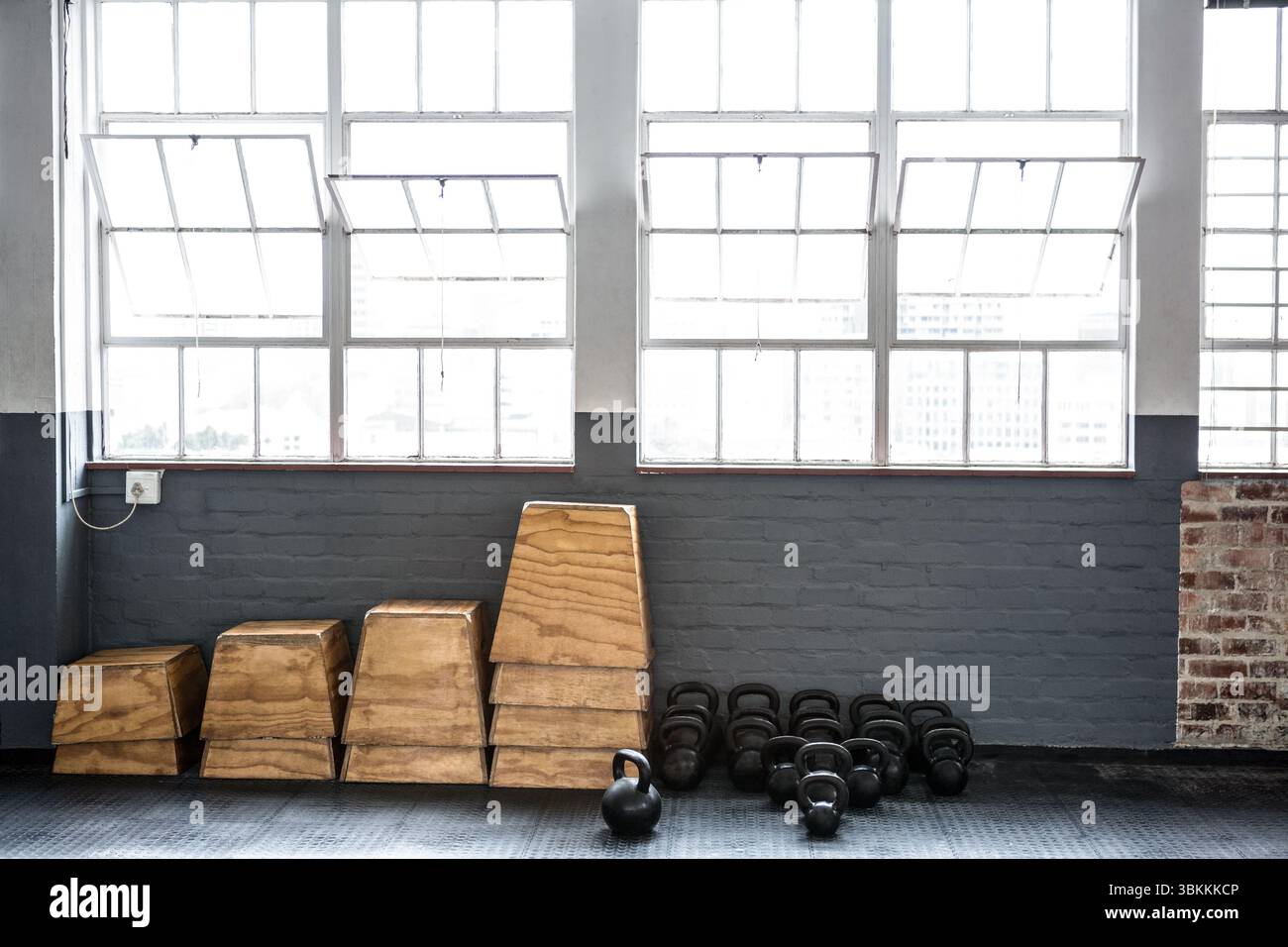 Flat design gym corner showing wooden plyo boxes and kettlebells under ...