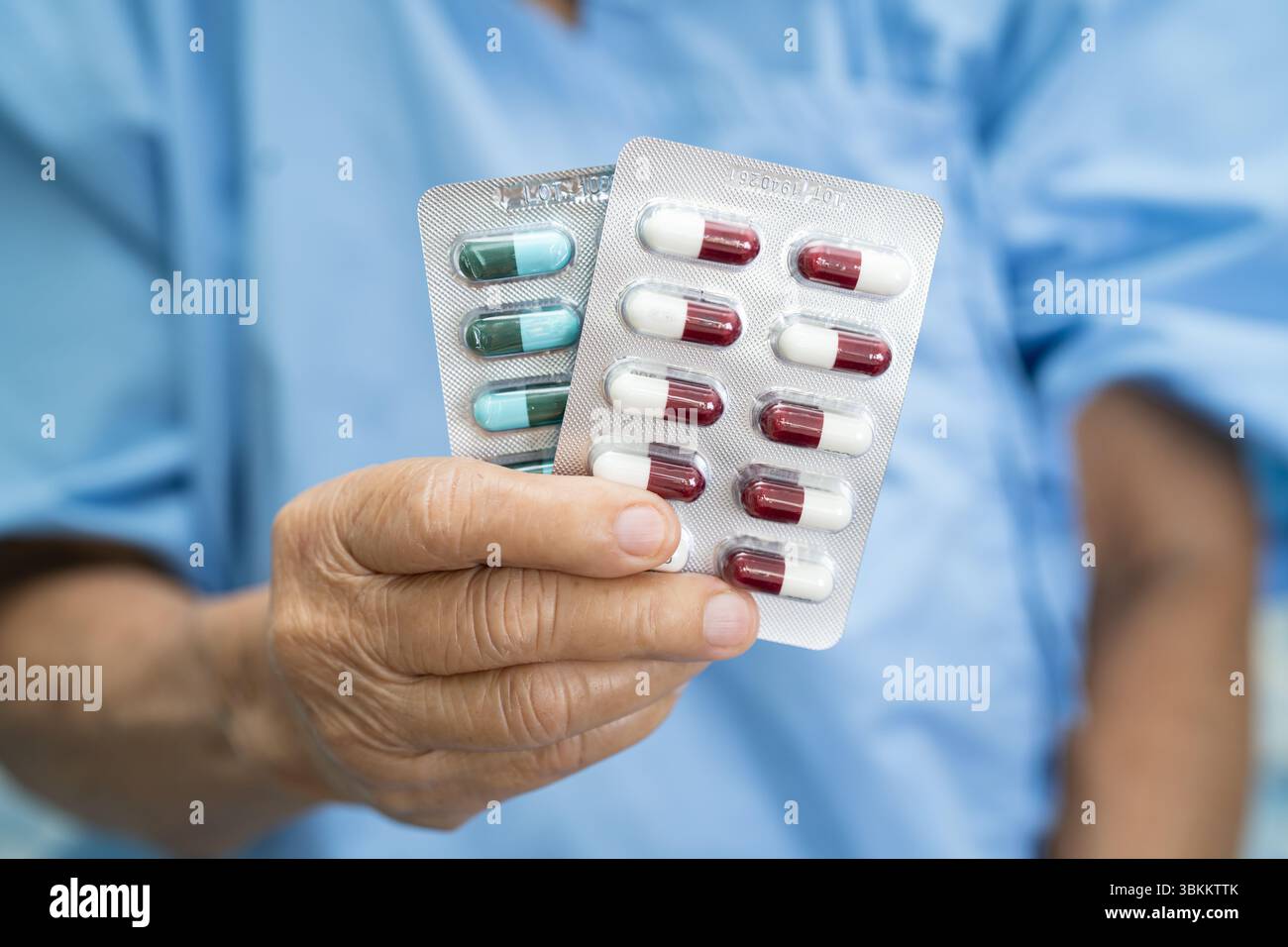 Asian senior or elderly old lady woman patient holding antibiotics ...