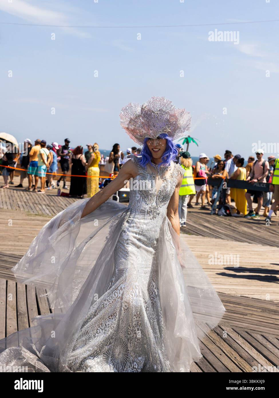 A costumed marcher poses for photos at the 2025 Coney Island Mermaid ...