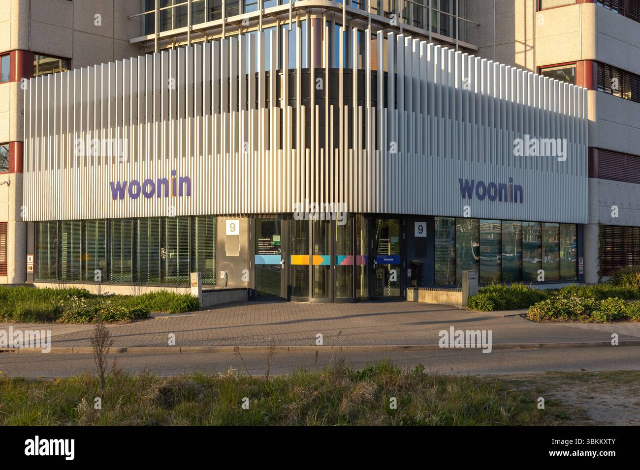 Modern office building of Woonin, featuring contemporary design with vertical slats and glass ...