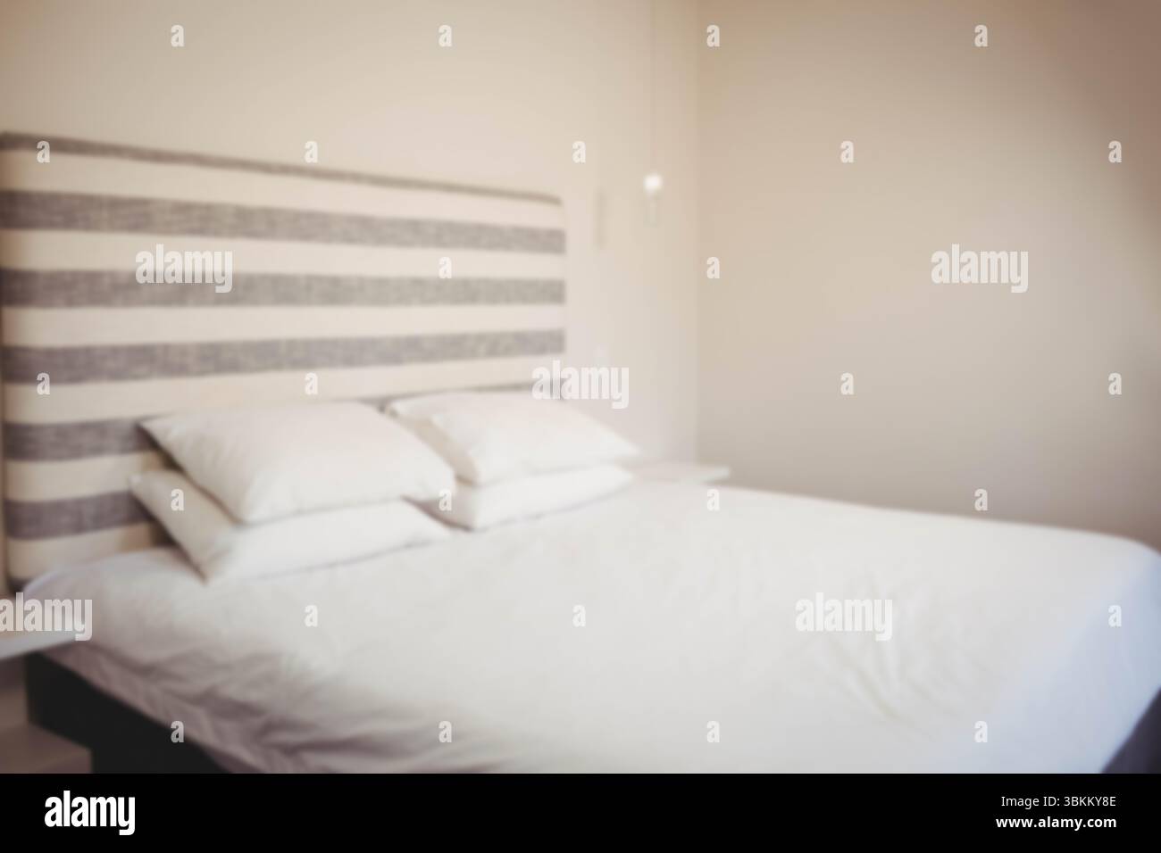 Bed against wall in bedroom Stock Photo - Alamy