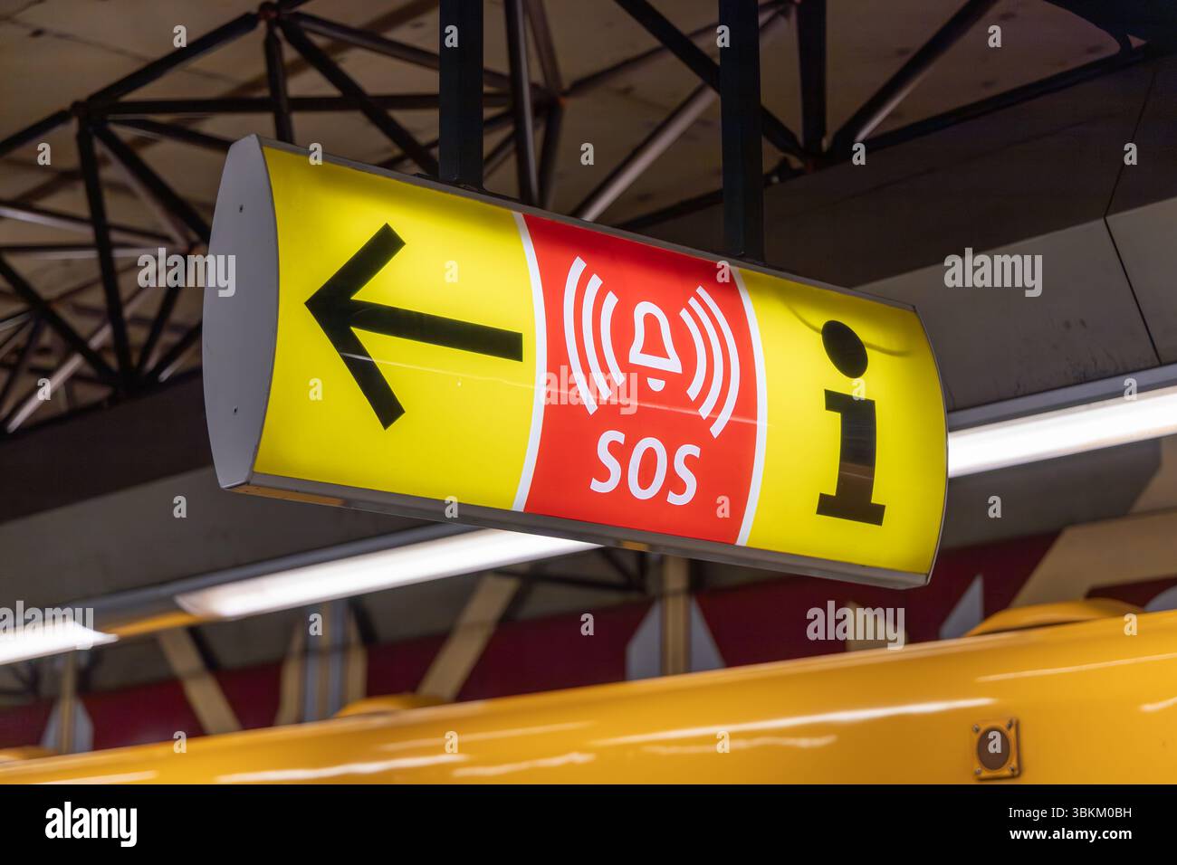 Yellow and red sign indicating the direction of an SOS emergency alarm ...