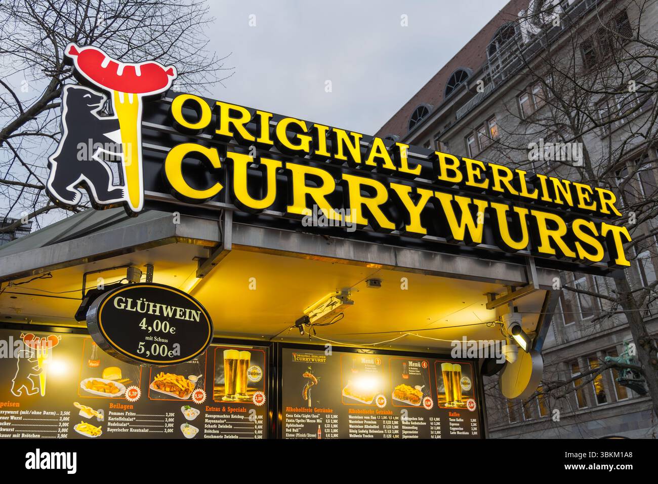 Illuminated "Original Berliner Currywurst" stand with a bear logo ...