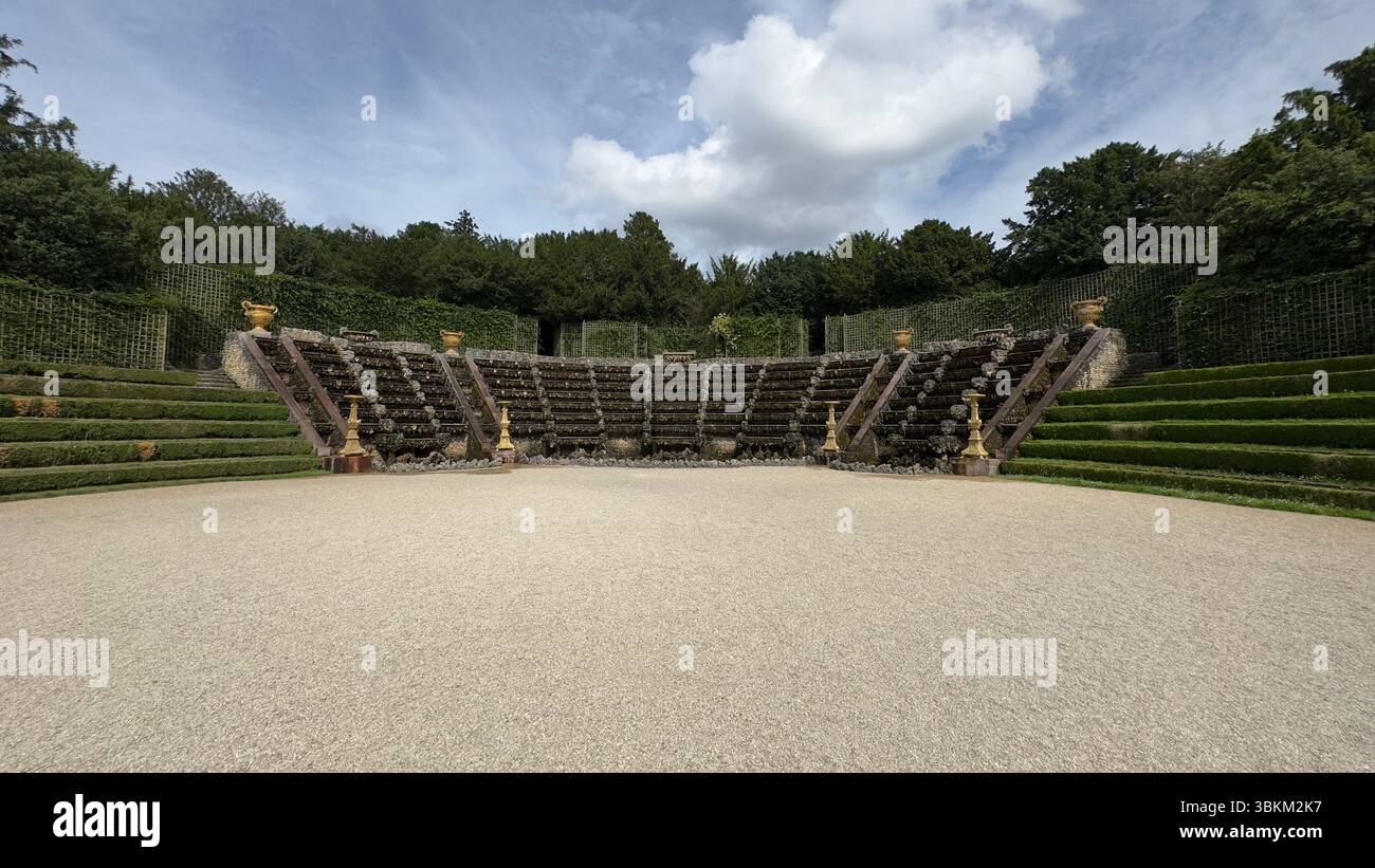 Outdoor amphitheater with tiered water feature, manicured greenery, and ...