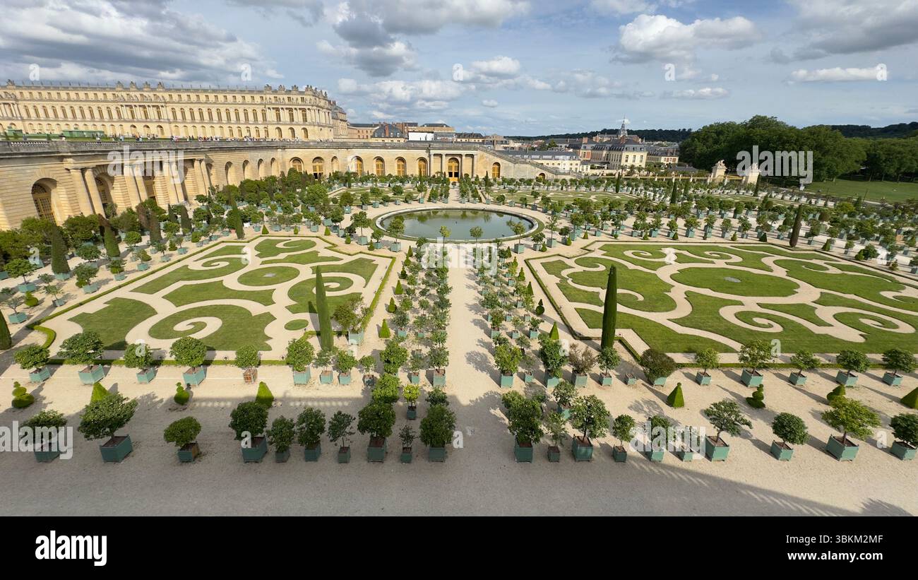 Panoramic view of Palace of Versailles gardens featuring geometric ...