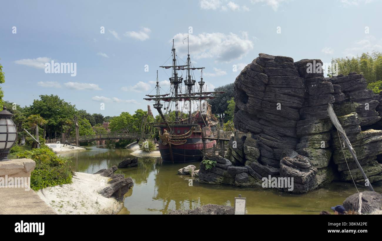 Pirate ship docked in a waterway, surrounded by rocks, trees, and a ...