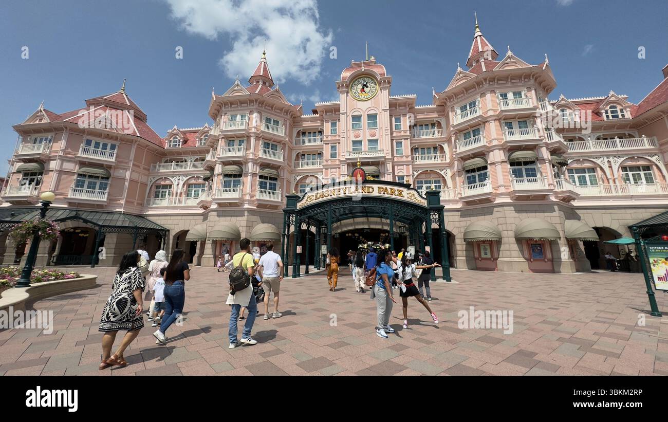 Exterior view of Disneyland Park entrance featuring a pink building ...