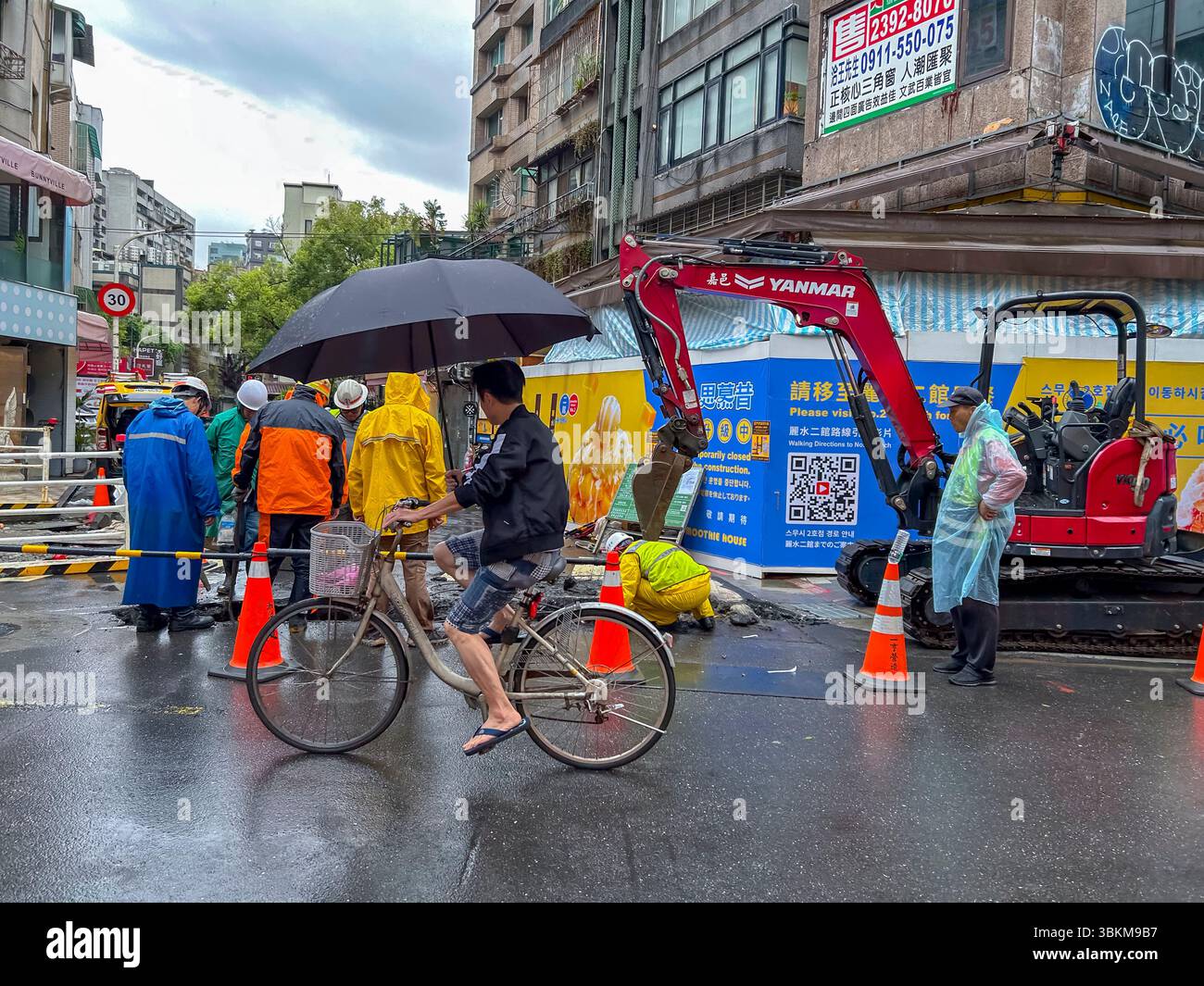 Taipei, Taiwan, Crowd People, Street Scene, Man Cycling with umbrella ...