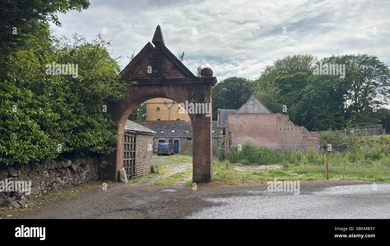 Entrance arch to Cranshaws Castle farm gateway—ornate late-19th C. red ...