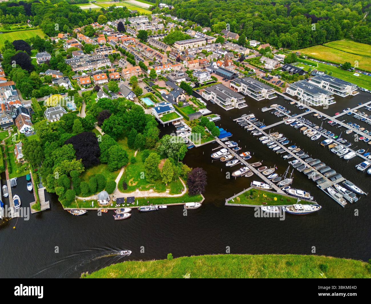 A top-down view of a marina with multiple boats docked along wooden ...