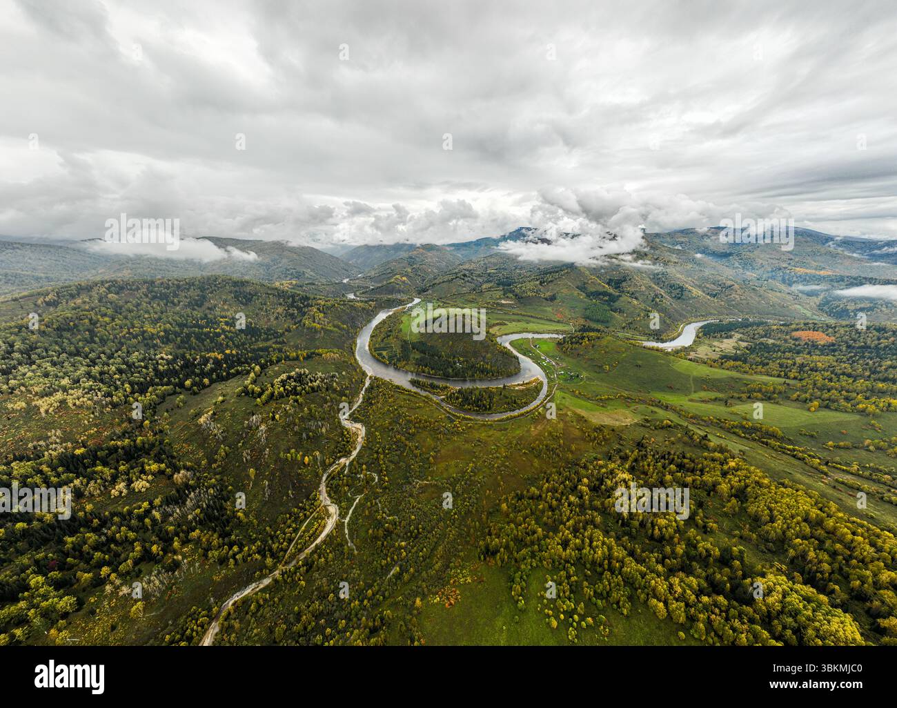 An aerial perspective captures a winding river carving its path through ...